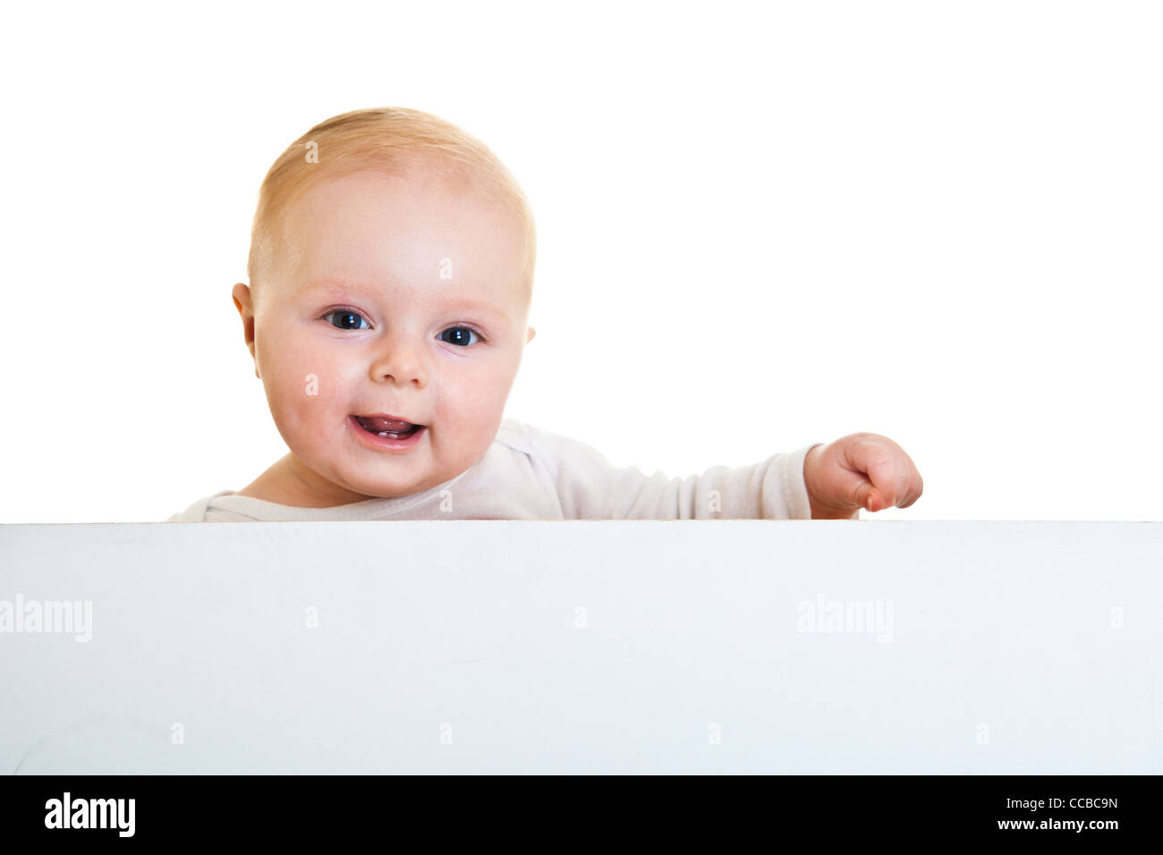 Infant baby behind whiteboard with lot of copyspace for advertisement ...