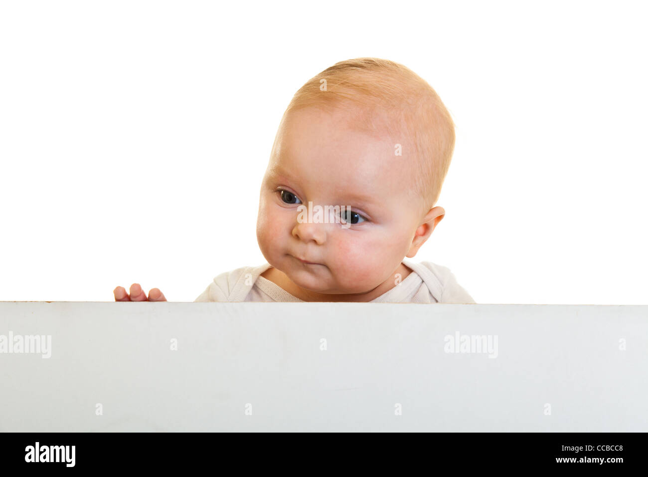 Infant baby behind whiteboard with lot of copyspace for advertisement ...