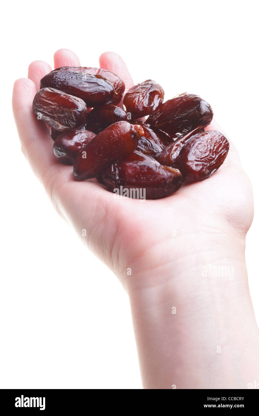Dried date fruits in hand isolated on white background Stock Photo - Alamy