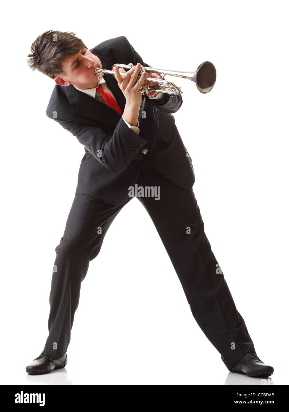 Portrait of a young man playing his Trumpet plays isolated white ...