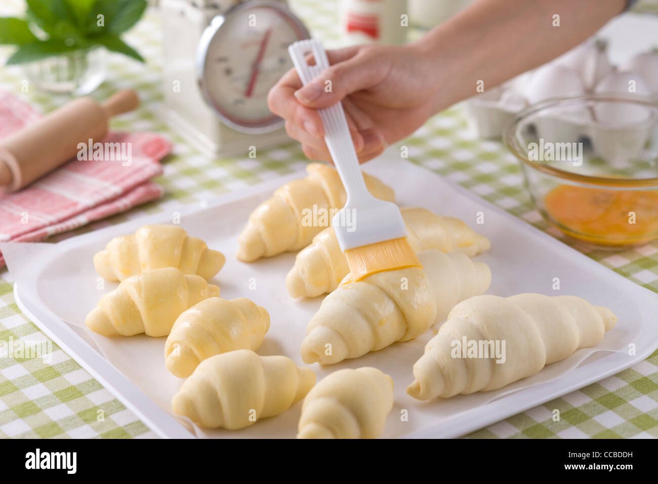 Human Hand Spreading Yolk on Dough of Croissant Stock Photo - Alamy