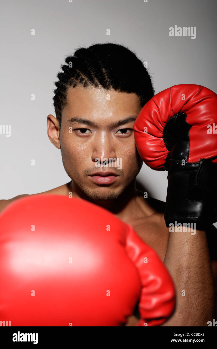 head shot of young man with red boxing gloves Stock Photo - Alamy