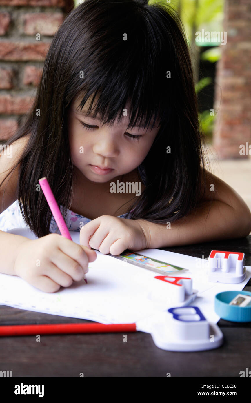 young girl writing on paper Stock Photo - Alamy