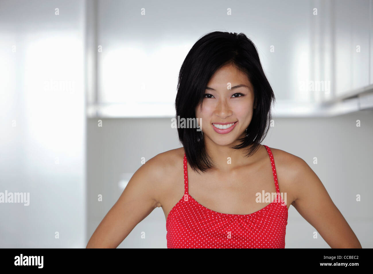 young woman wearing red top and smiling Stock Photo - Alamy
