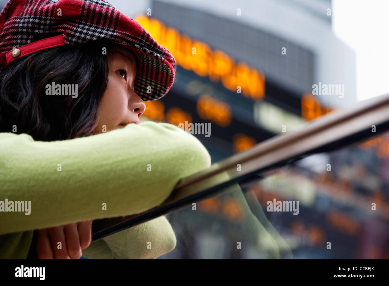woman wearing hat looking over railing Stock Photo - Alamy
