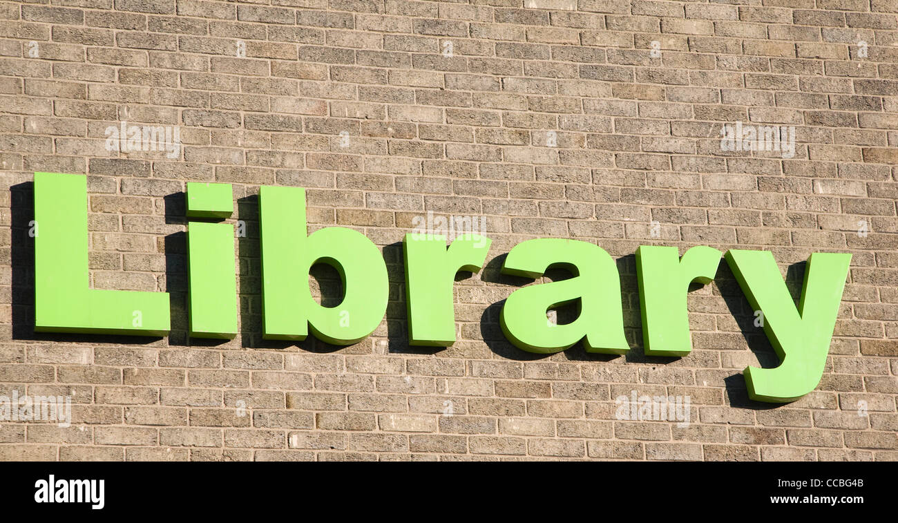 Library sign green letter brick wall Stock Photo - Alamy