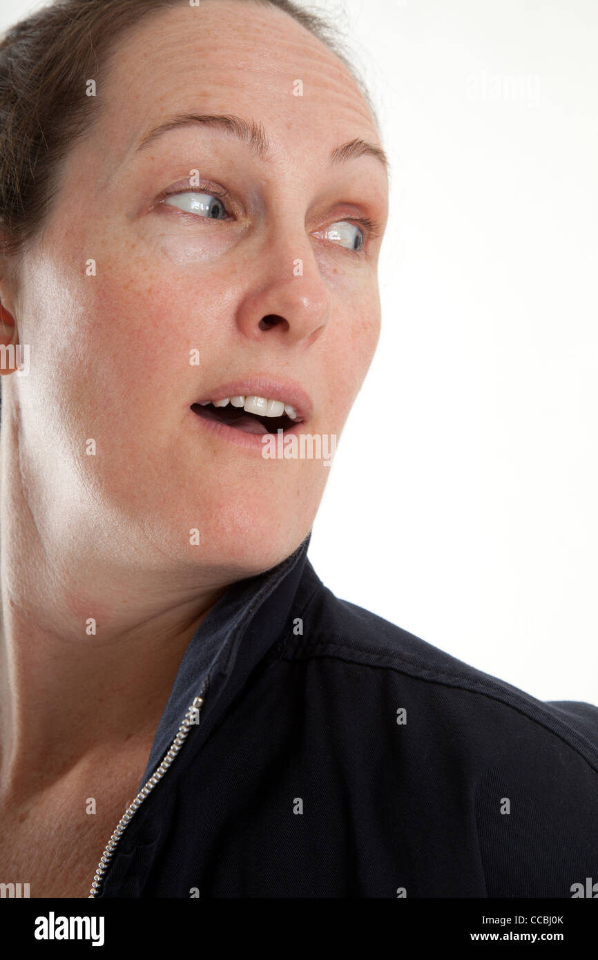Woman looking over shoulder in alarm Stock Photo - Alamy