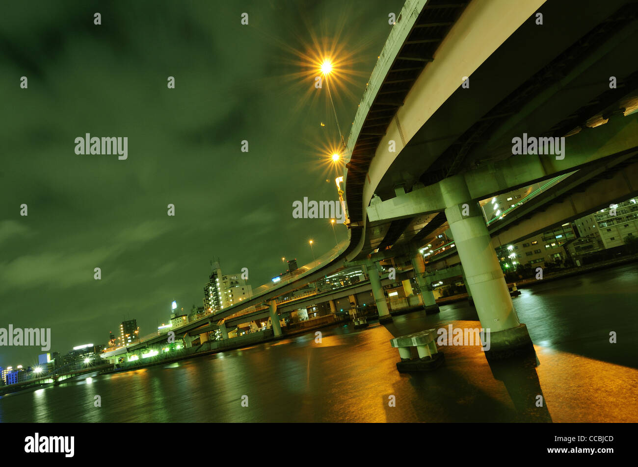 huge highway structure going through the night over river waters Stock ...