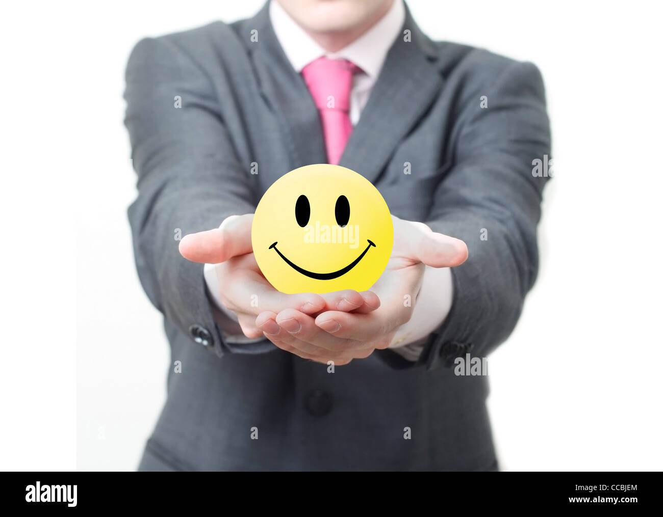 Businessman holding smiley Stock Photo - Alamy