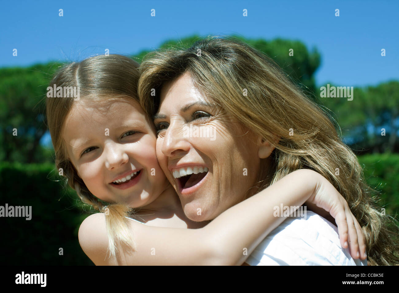 Happy mother and daughter embracing Stock Photo - Alamy
