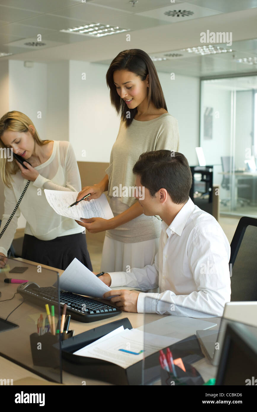 Colleagues collaborating in office Stock Photo - Alamy