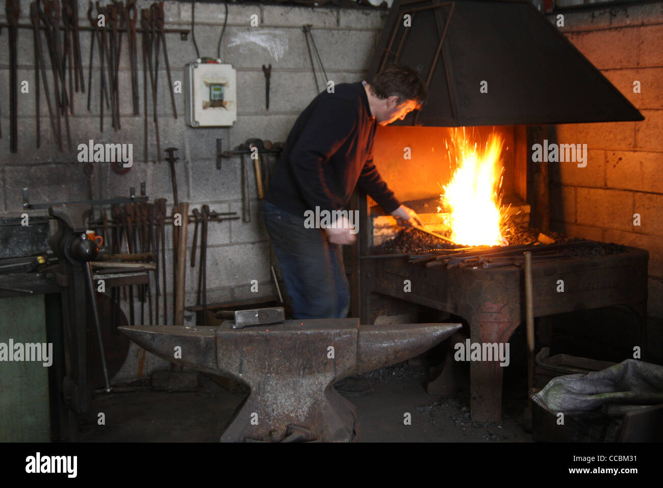 Metal being shaped at a forge Stock Photo - Alamy