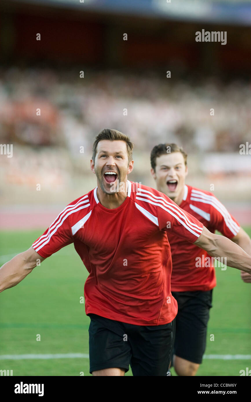 Soccer players shouting in victory Stock Photo - Alamy