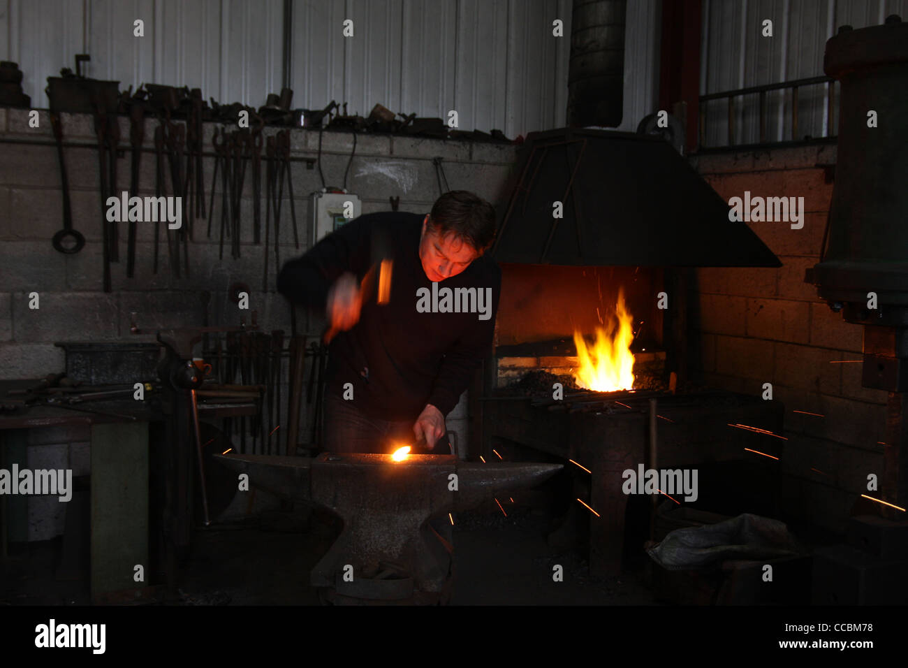 Metal being shaped at a forge Stock Photo - Alamy