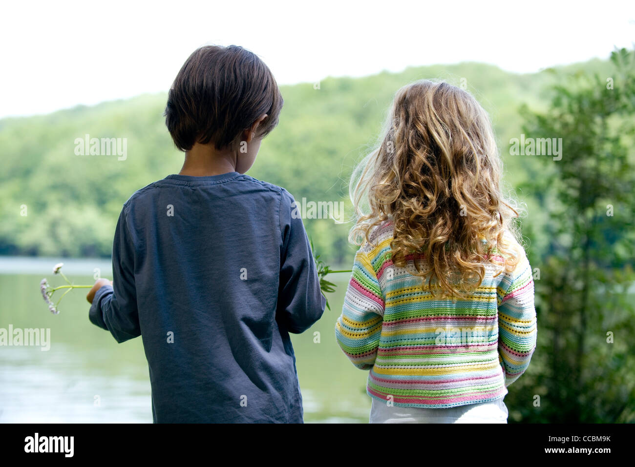 Children looking at lake view Stock Photo - Alamy