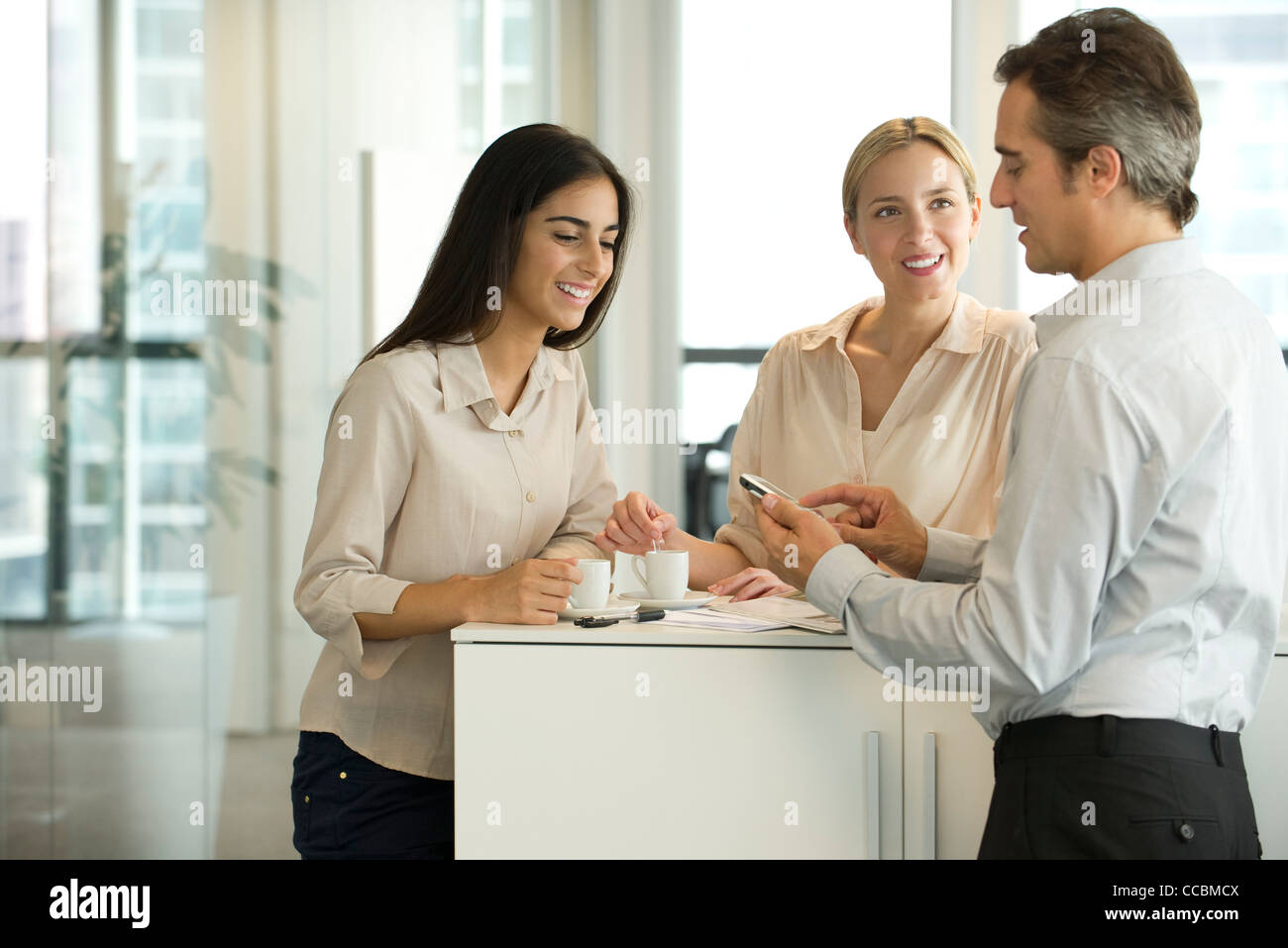 Colleagues enjoying coffee break together Stock Photo - Alamy