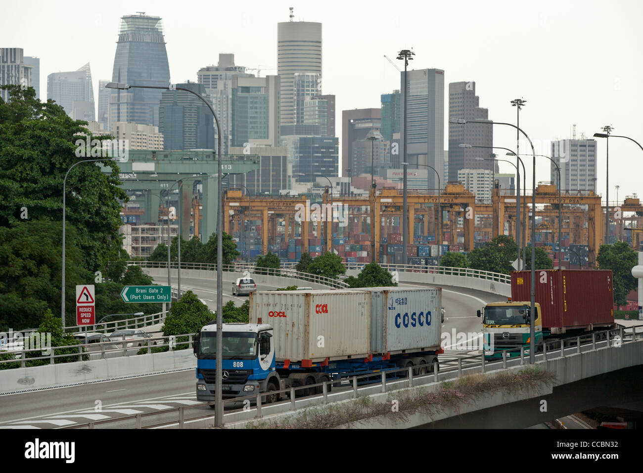 A truck transports a cargo container along an elevated section of road ...