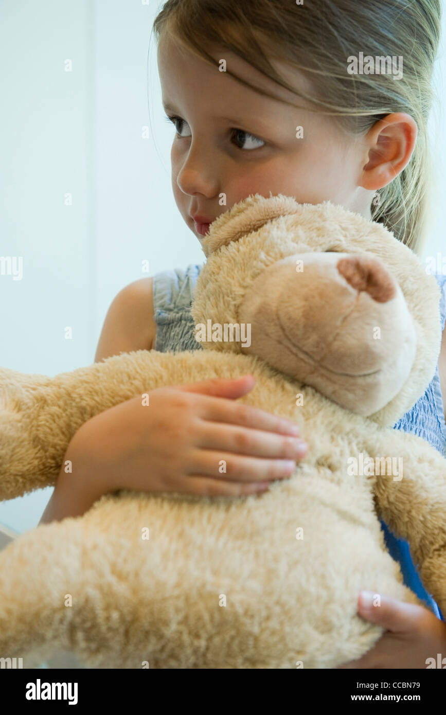 Little girl hugging teddy bear Stock Photo - Alamy