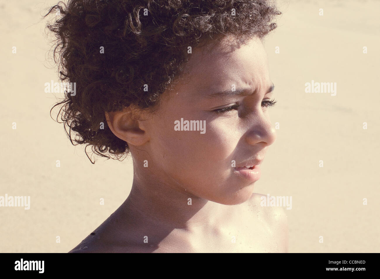 Boy squinting in sun, portrait Stock Photo - Alamy