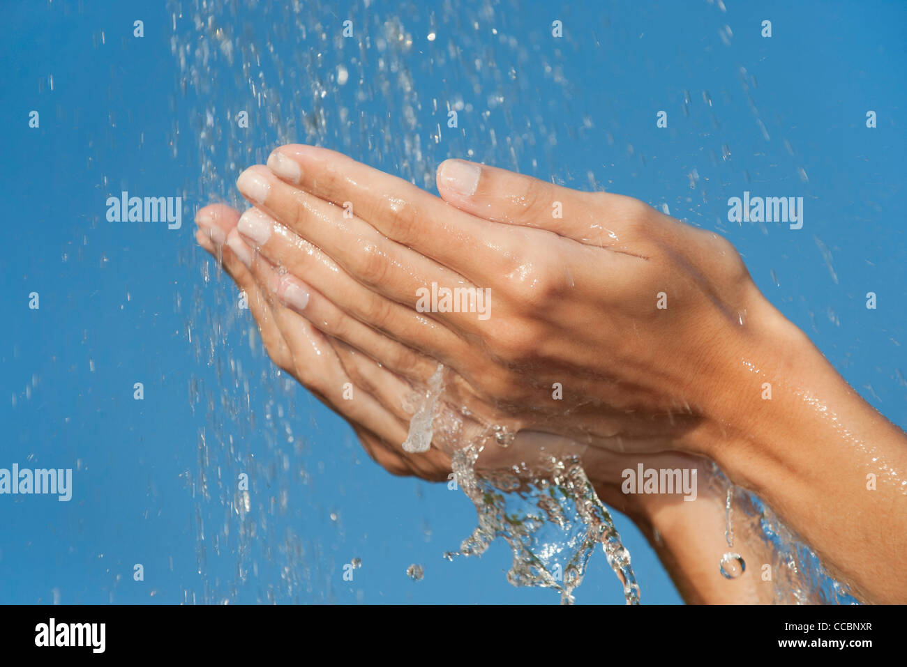 Hands under splashing water Stock Photo - Alamy