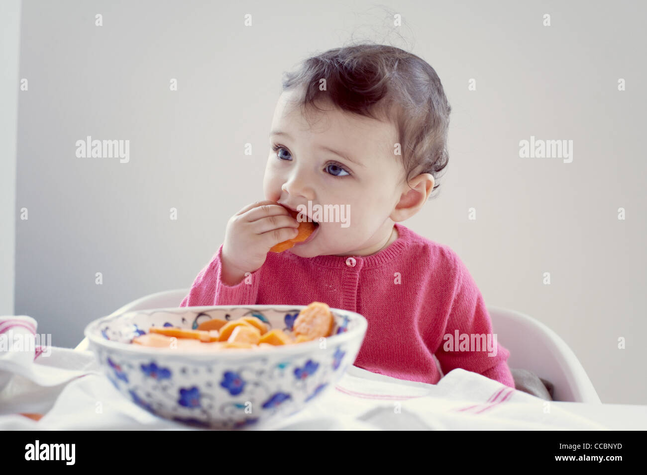 Infant eating carrots, portrait Stock Photo - Alamy