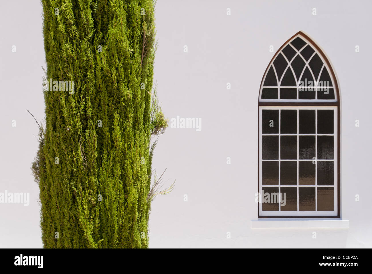 White church with cypress and window closeup - portrait Stock Photo - Alamy