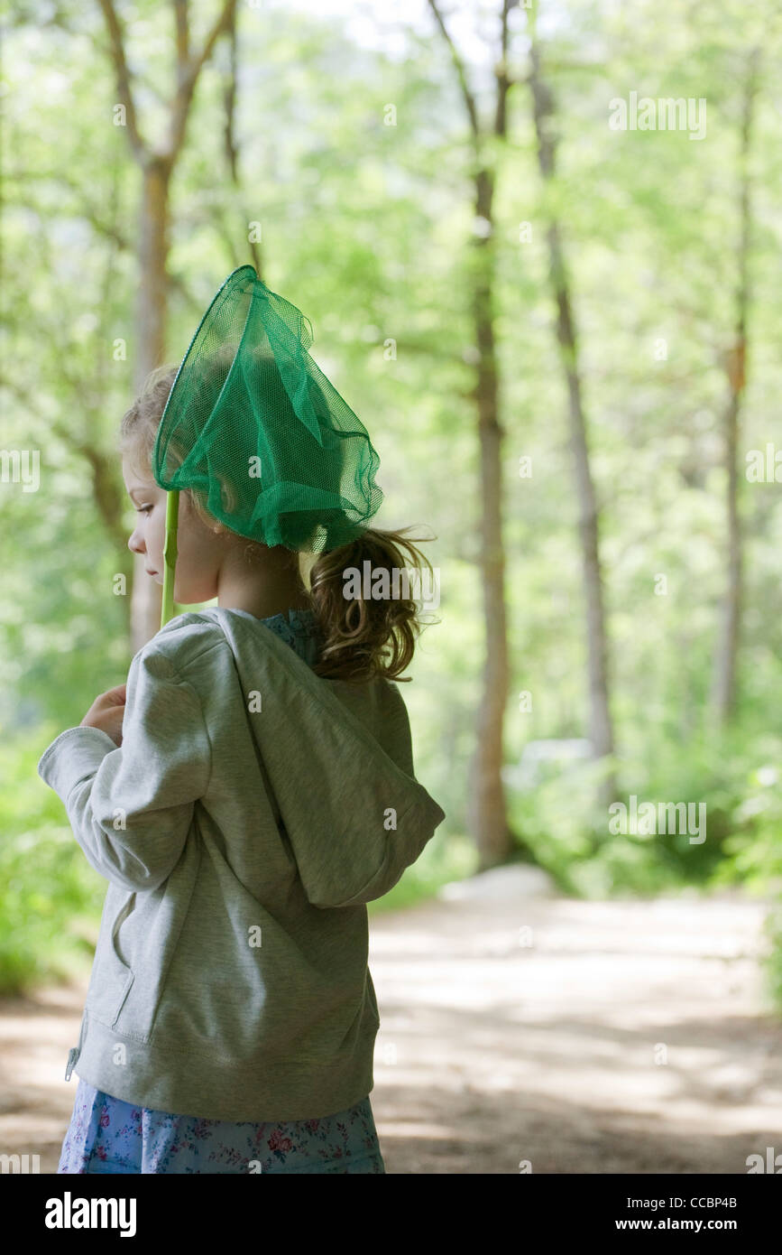 Girl carrying butterfly net in woods Stock Photo - Alamy