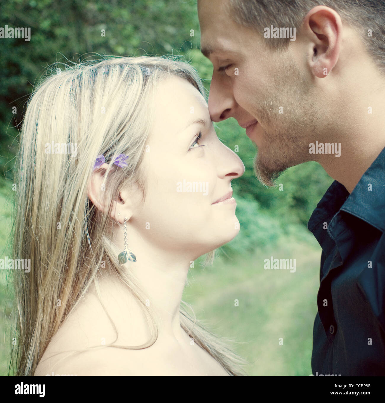 Couple nuzzling outdoors Stock Photo - Alamy