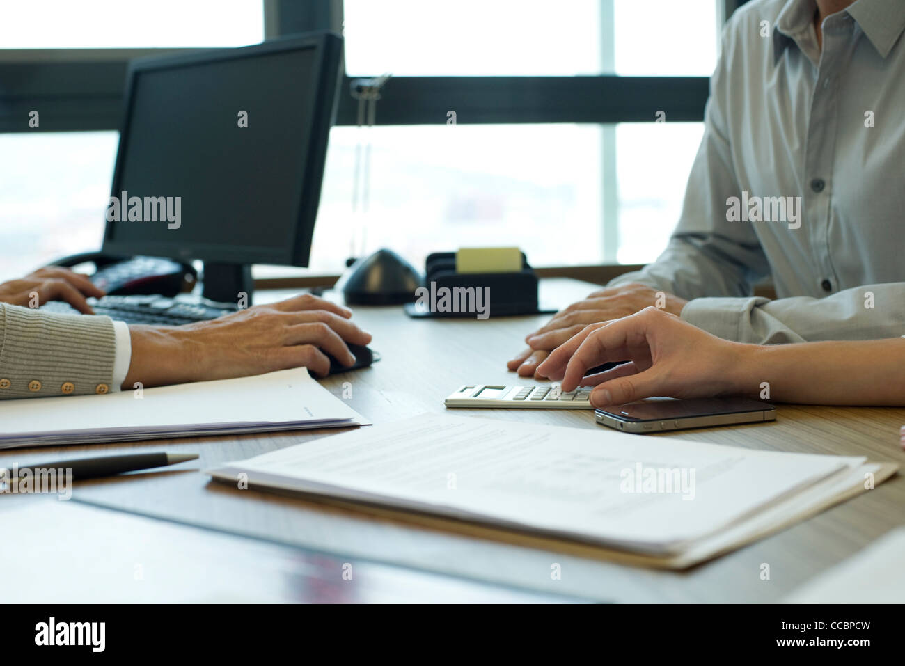 Business associates negotiating deal, cropped Stock Photo - Alamy