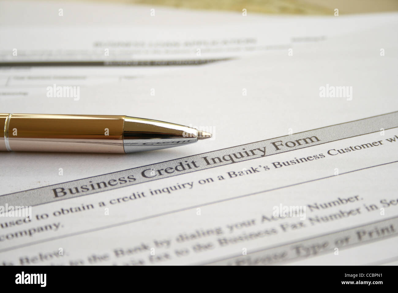 golden pen on gray document paper Stock Photo - Alamy