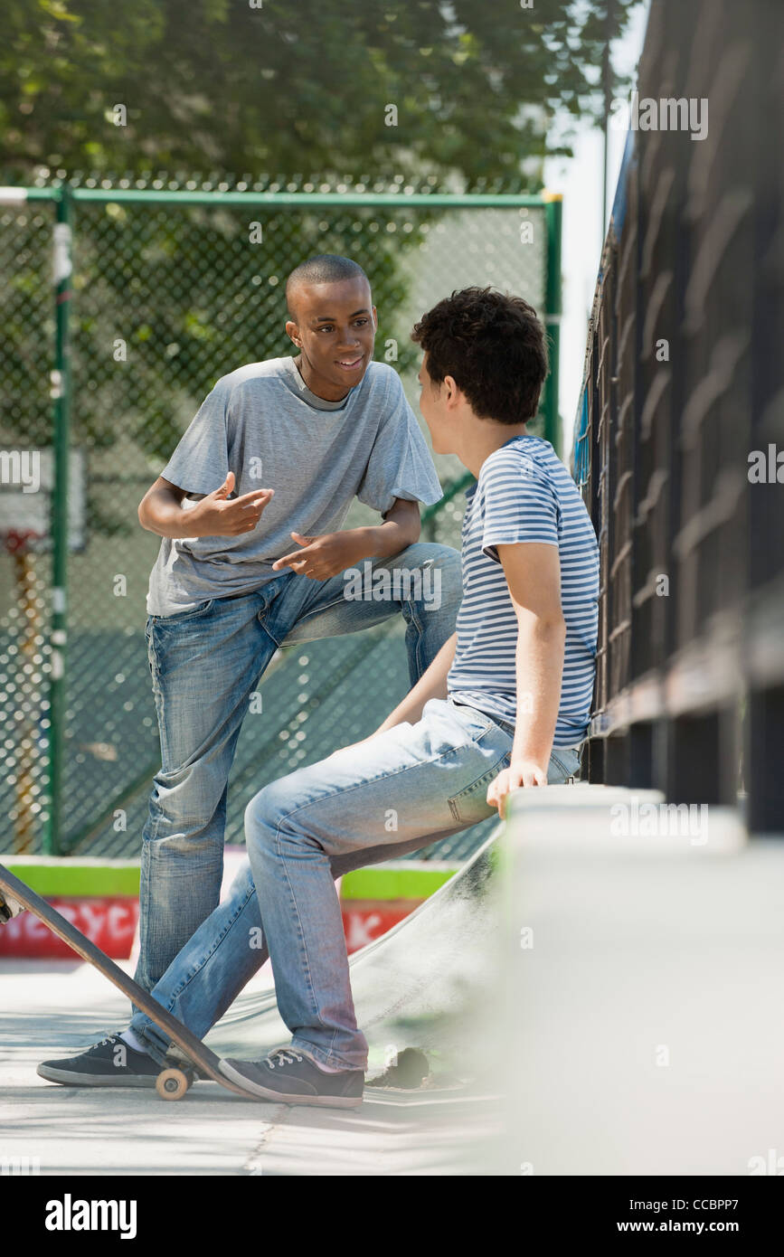 Young men talking Stock Photo - Alamy