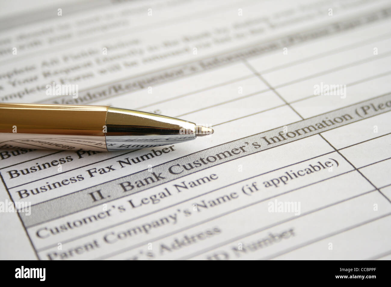 golden pen on gray document paper Stock Photo - Alamy