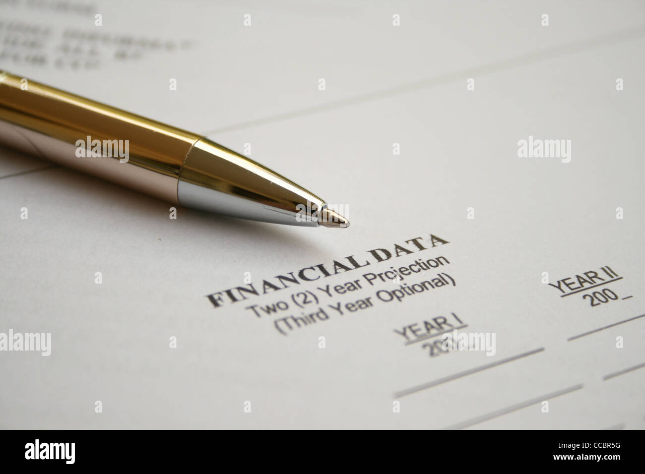 golden pen on gray document paper Stock Photo - Alamy