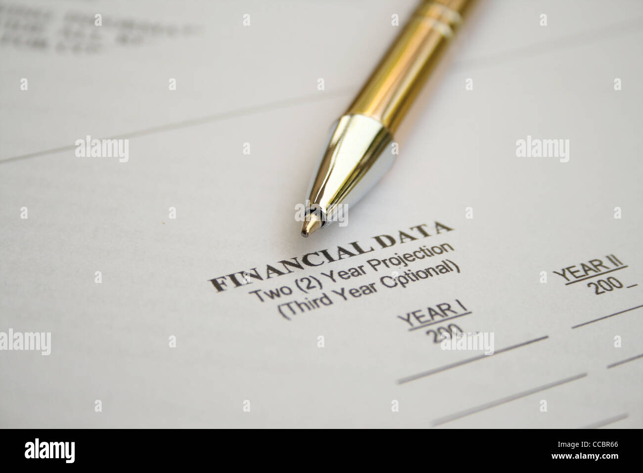 golden pen on gray document paper Stock Photo - Alamy