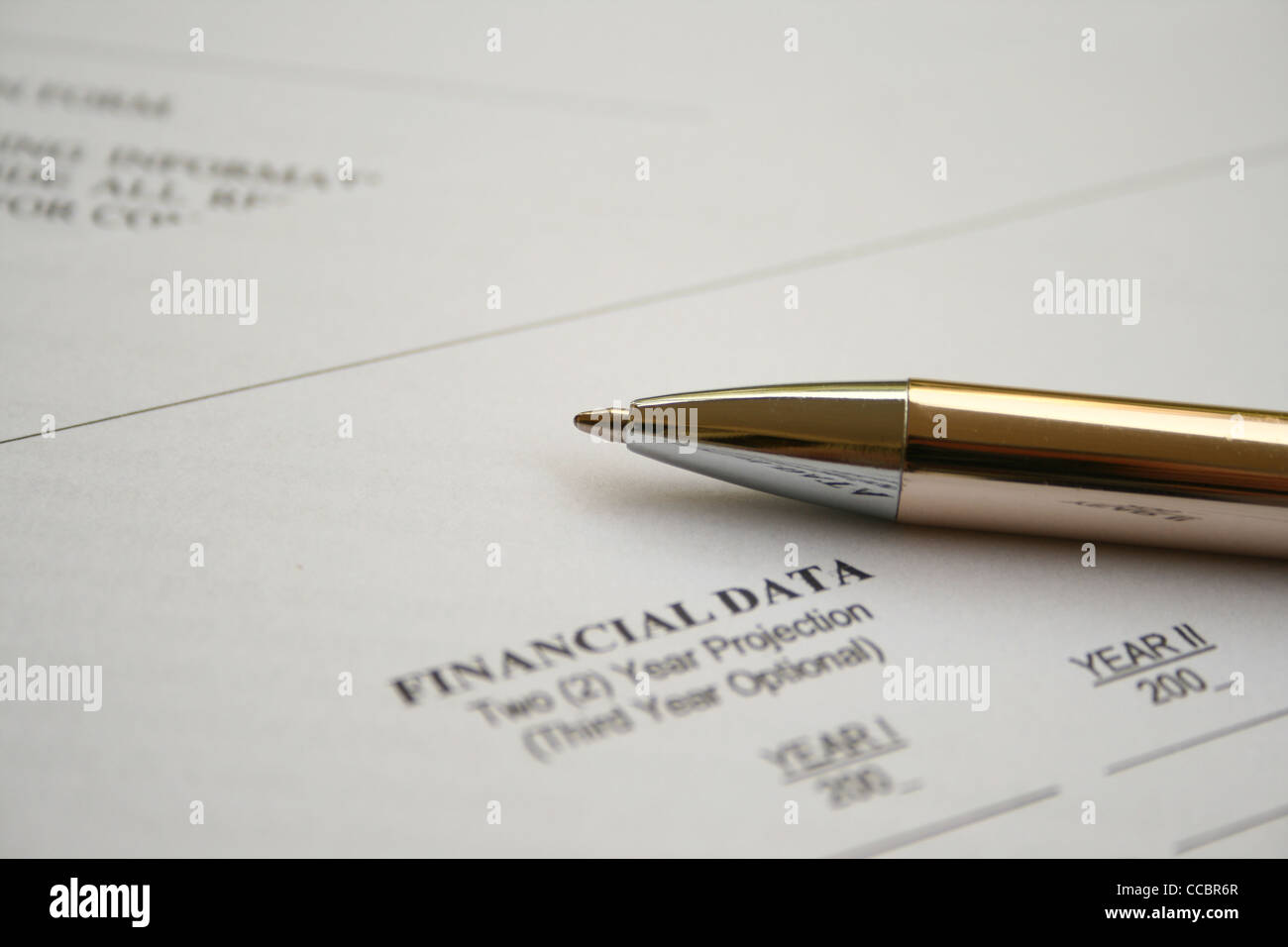 golden pen on gray document paper Stock Photo - Alamy