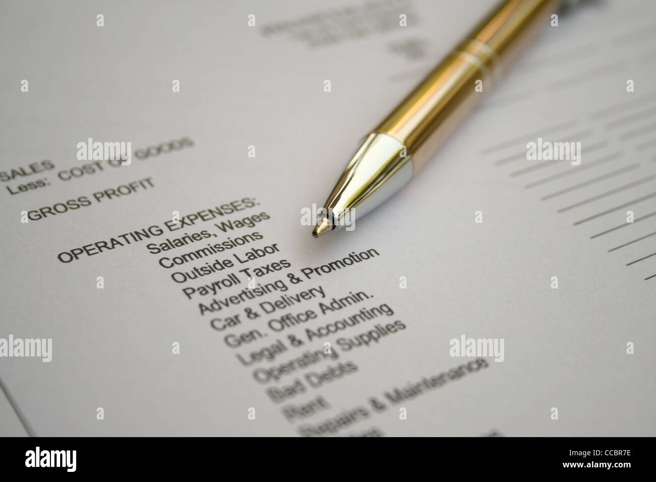 golden pen on gray document paper Stock Photo - Alamy
