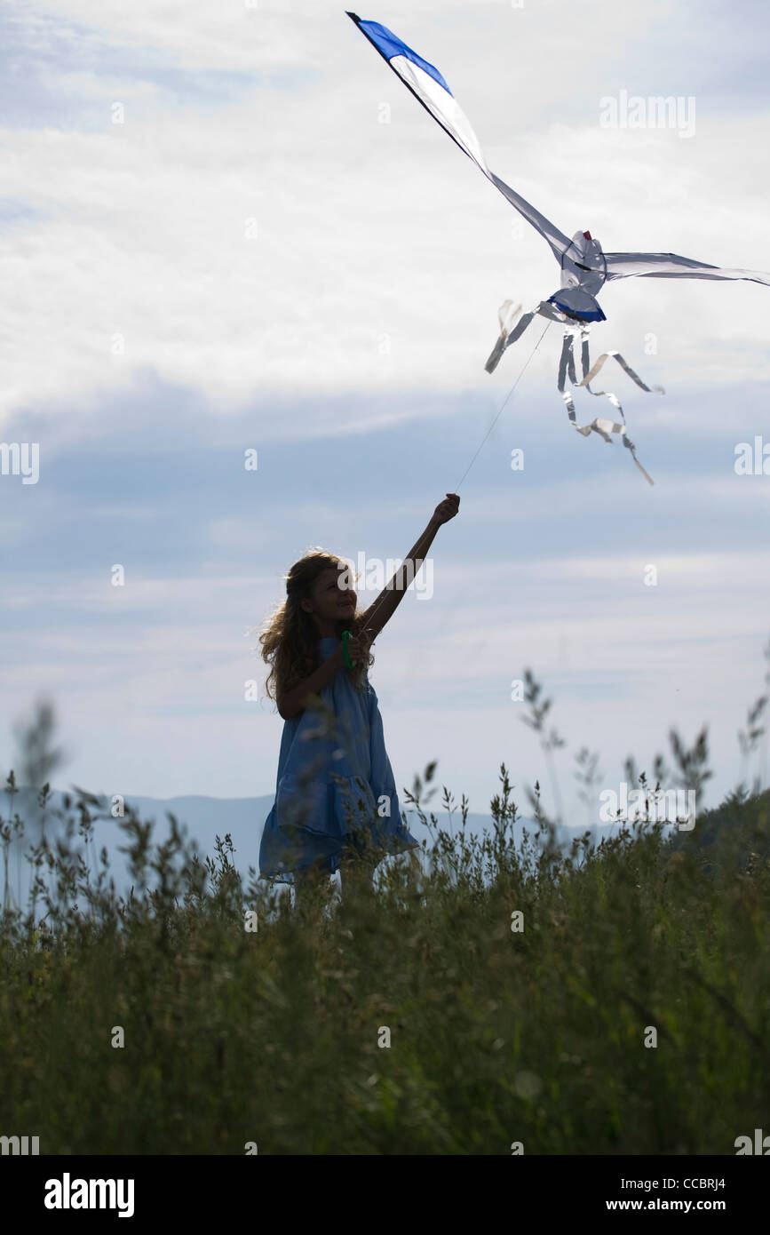 Girl flying kite Stock Photo - Alamy
