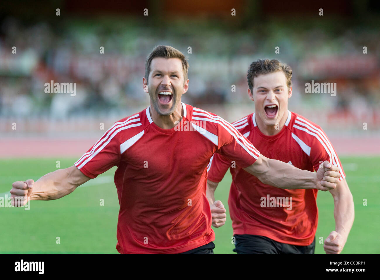 Soccer players shouting in victory Stock Photo - Alamy