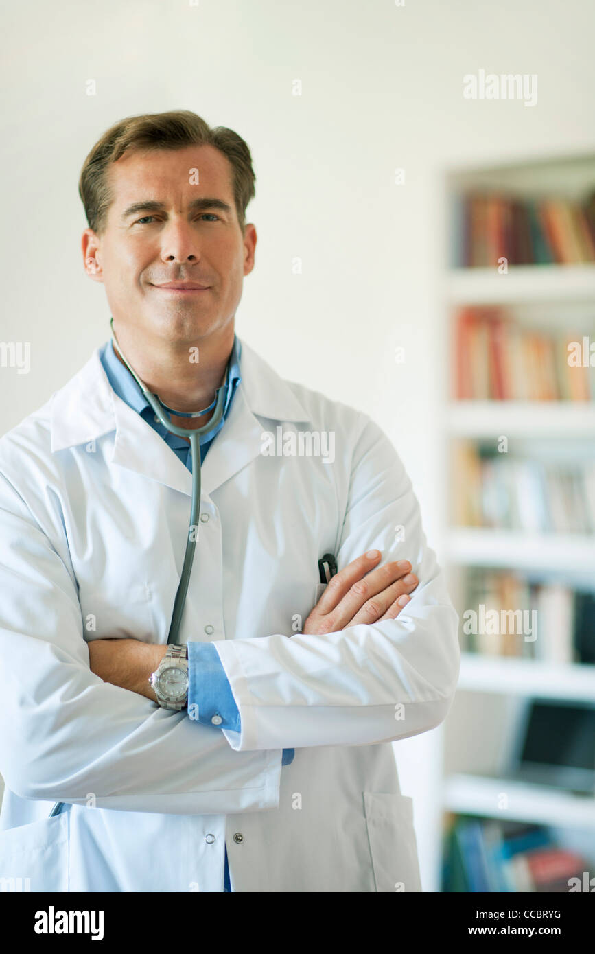 Doctor standing with arms folded, portrait Stock Photo - Alamy