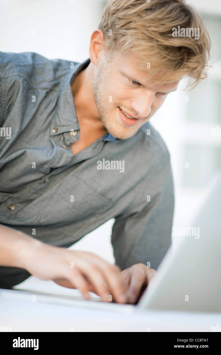 Man using laptop computer Stock Photo - Alamy