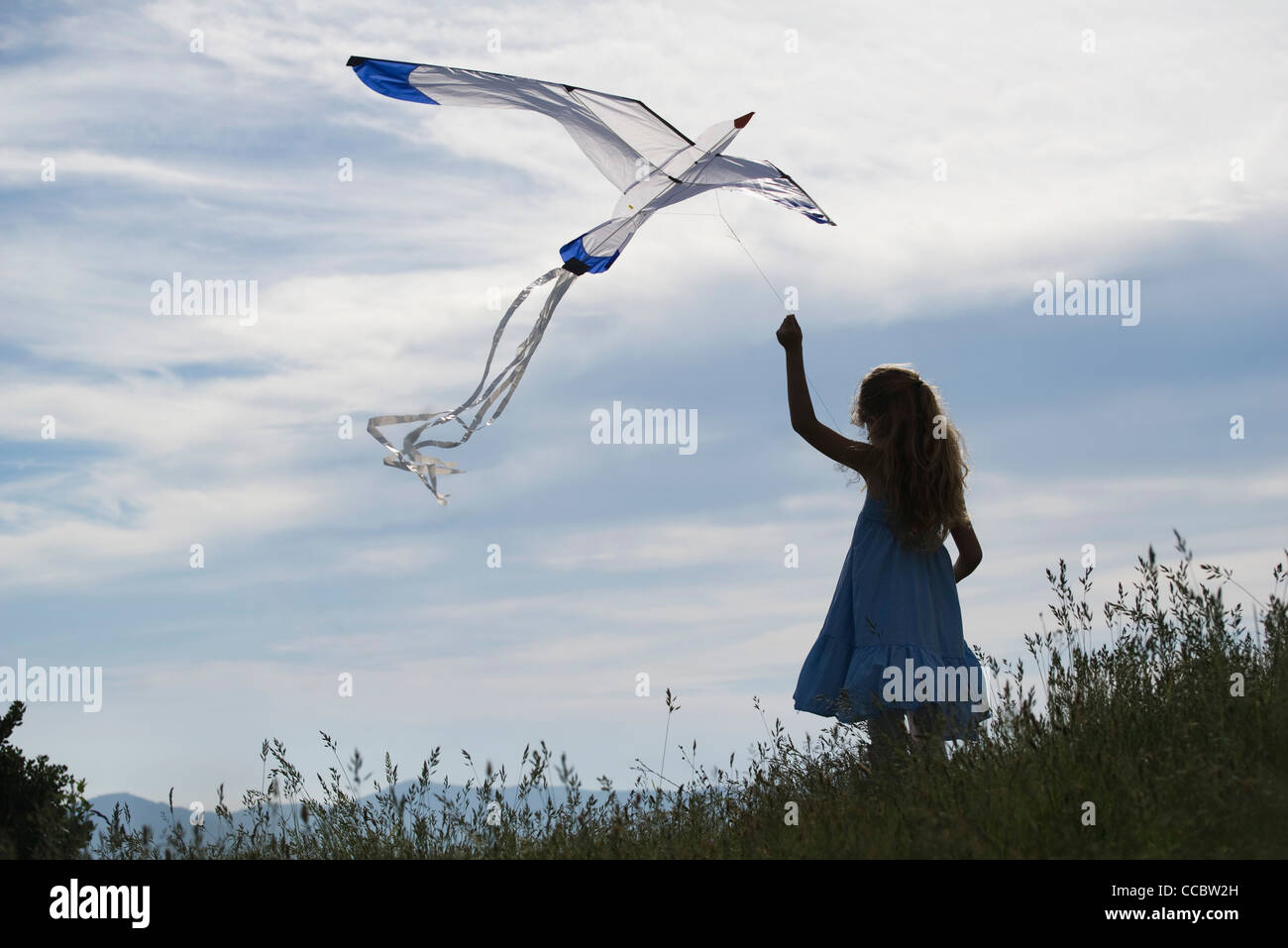 Girl flying kite Stock Photo - Alamy
