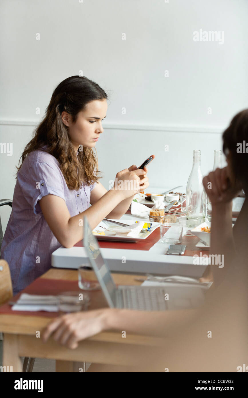 Young woman text messaging in restaurant Stock Photo - Alamy