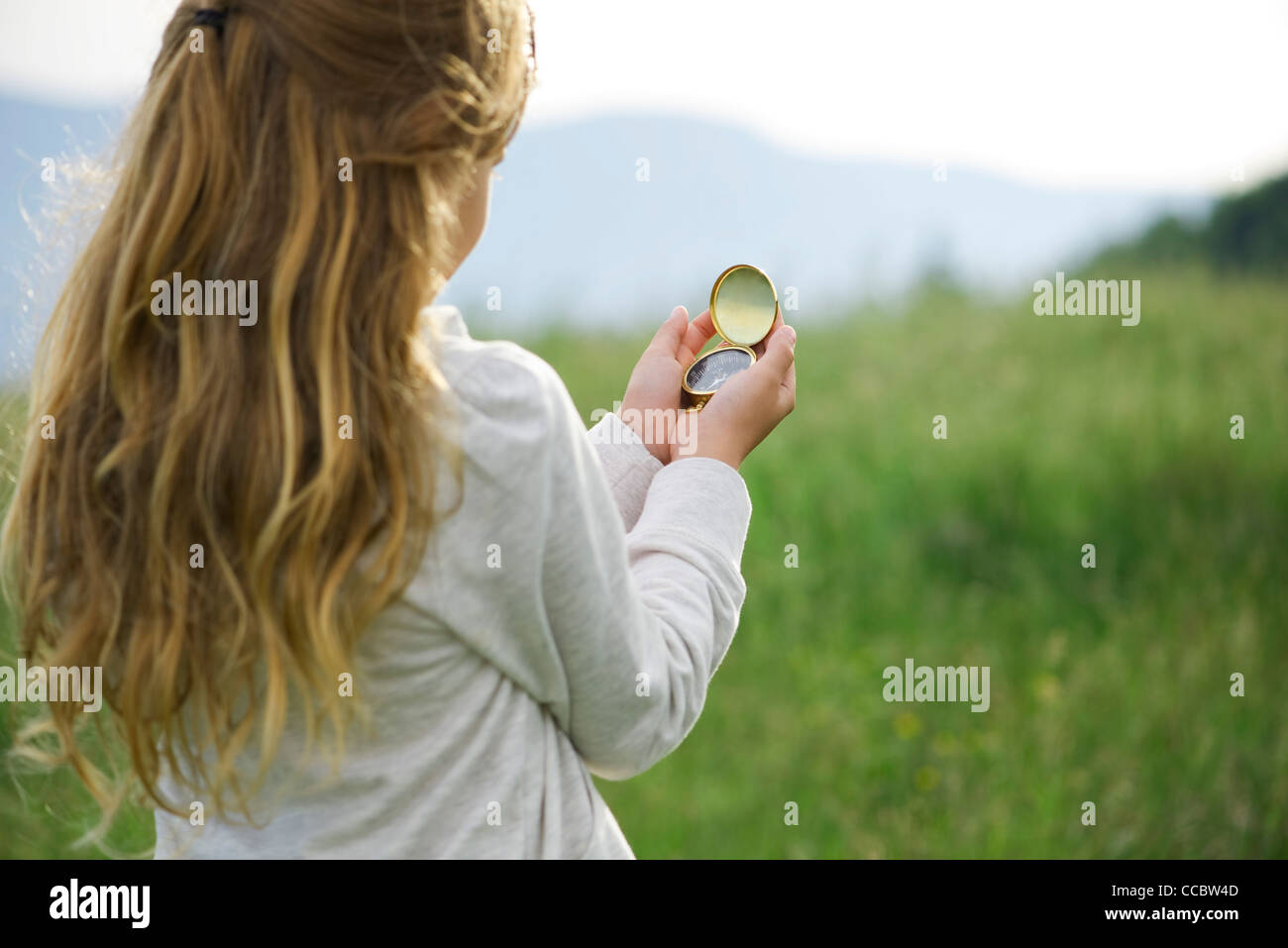 Girl using compass Stock Photo - Alamy