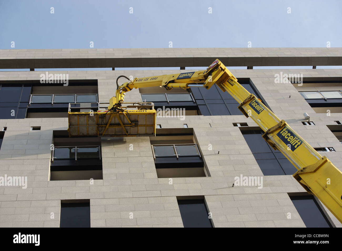 Cranes for maintenance workers on a tall building in Liverpool, England ...