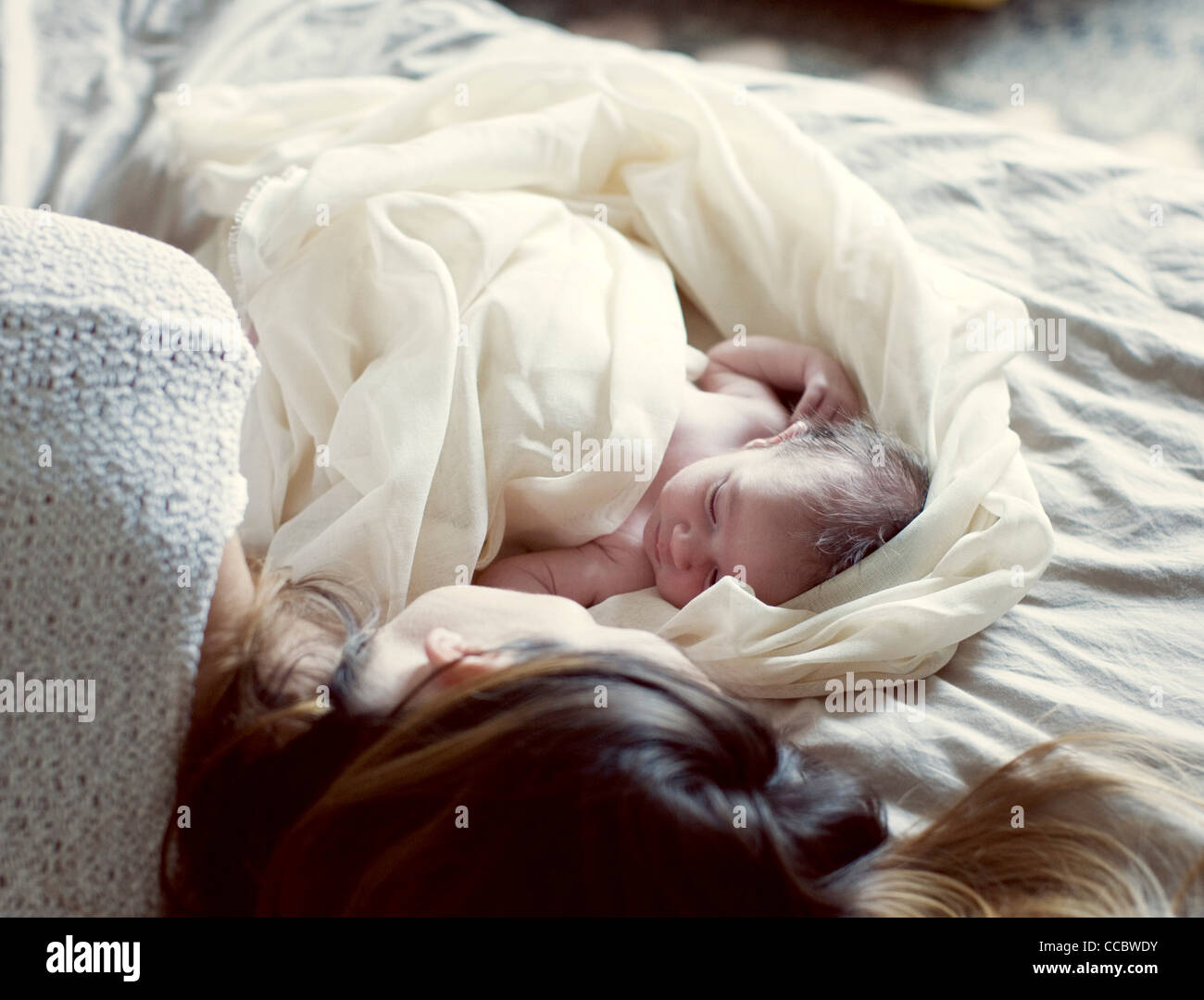 Child sleeps on his mothers back hi-res stock photography and images ...