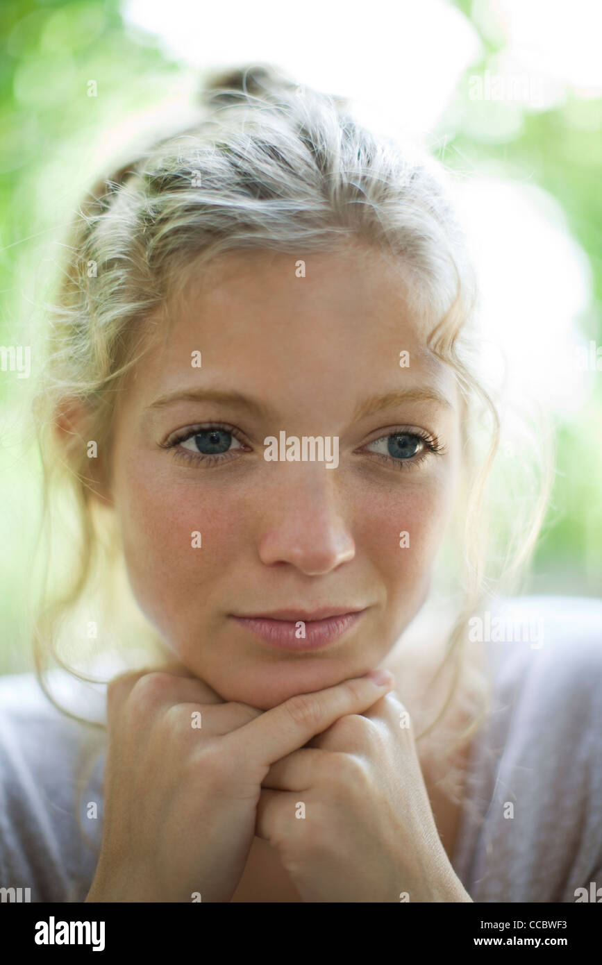 Woman resting chin on hands, looking away in thought, portrait Stock ...