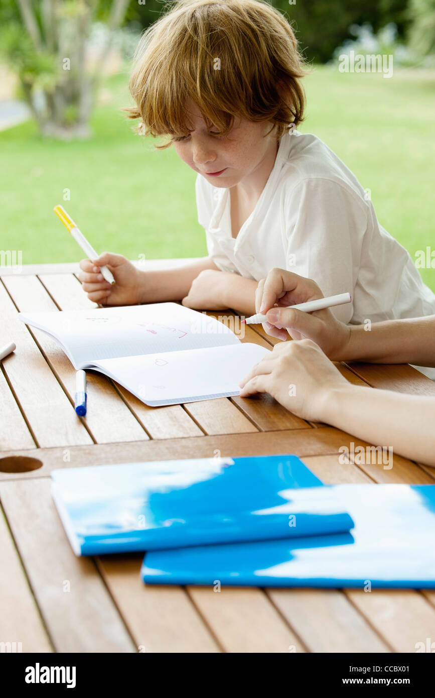 Boy coloring outdoors Stock Photo - Alamy