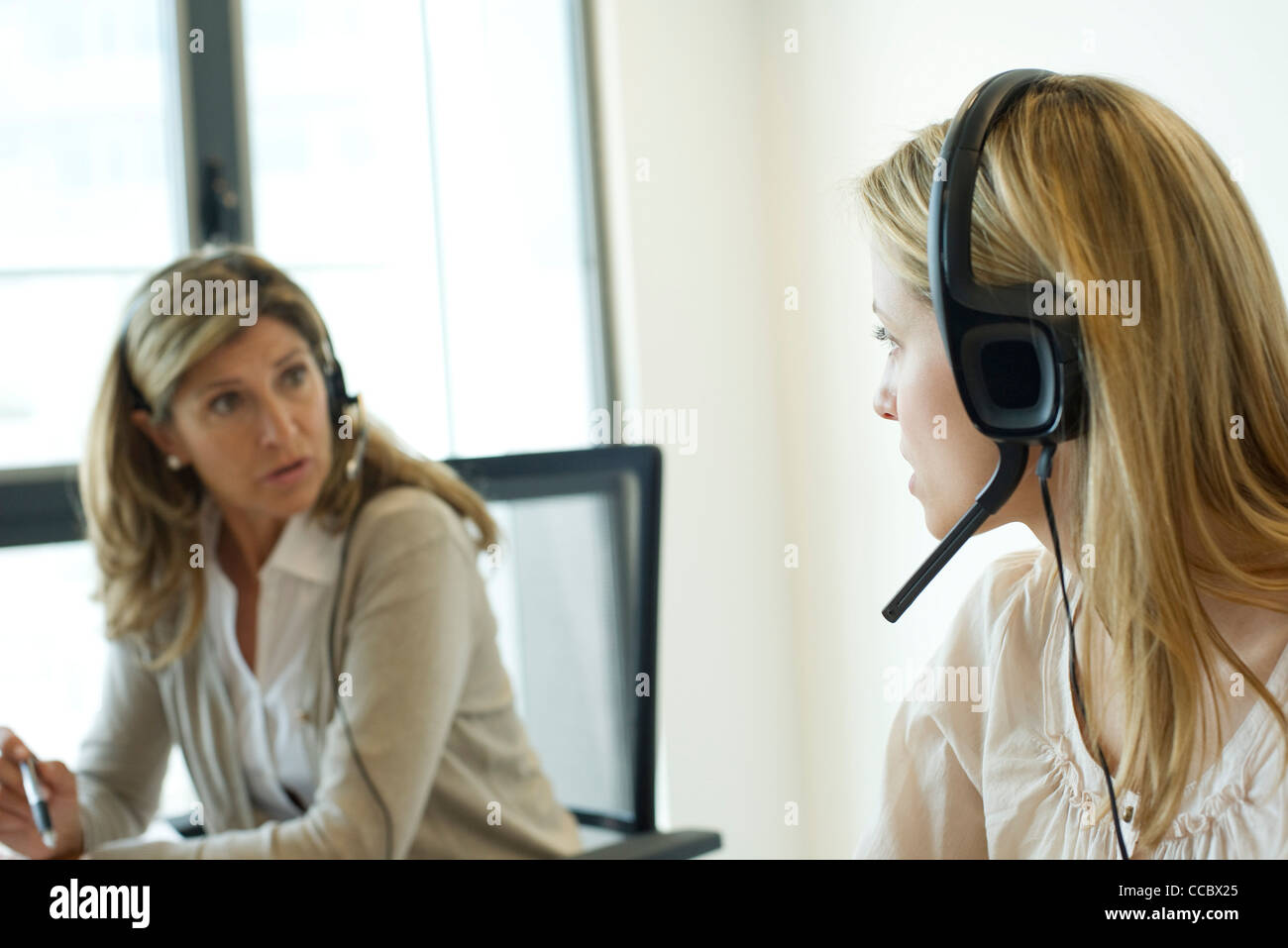 Two business people wearing headsets hi-res stock photography and ...