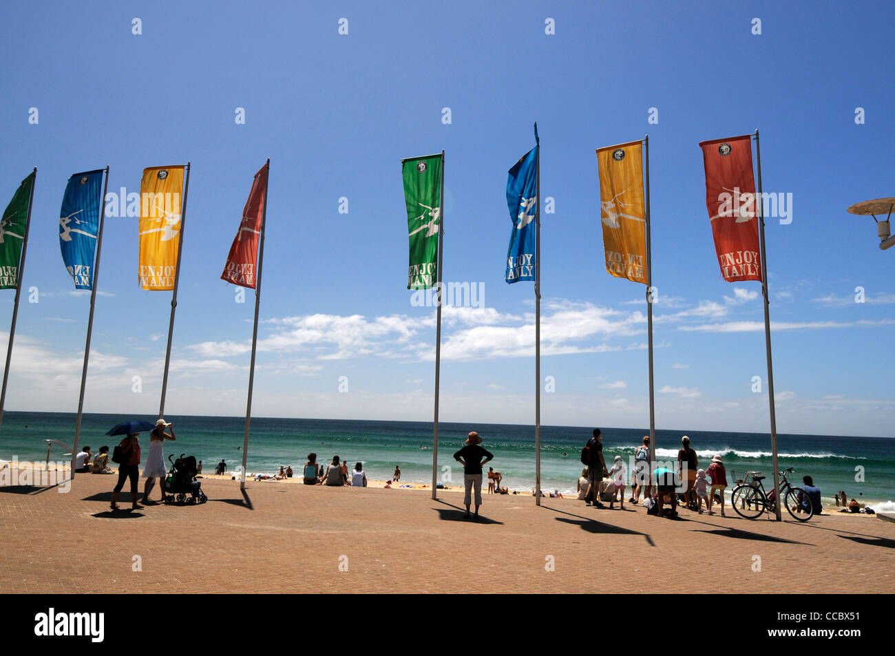 Colourful flags on Manly Beach seafront facing the Pacific Ocean near ...