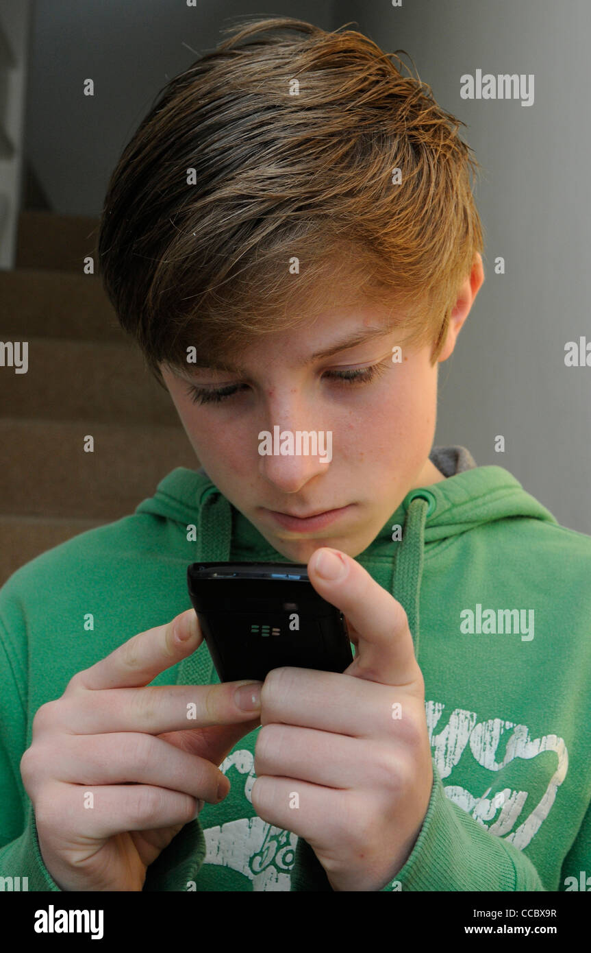 Teenage Boy Texting With Blackberry Stock Photo - Alamy